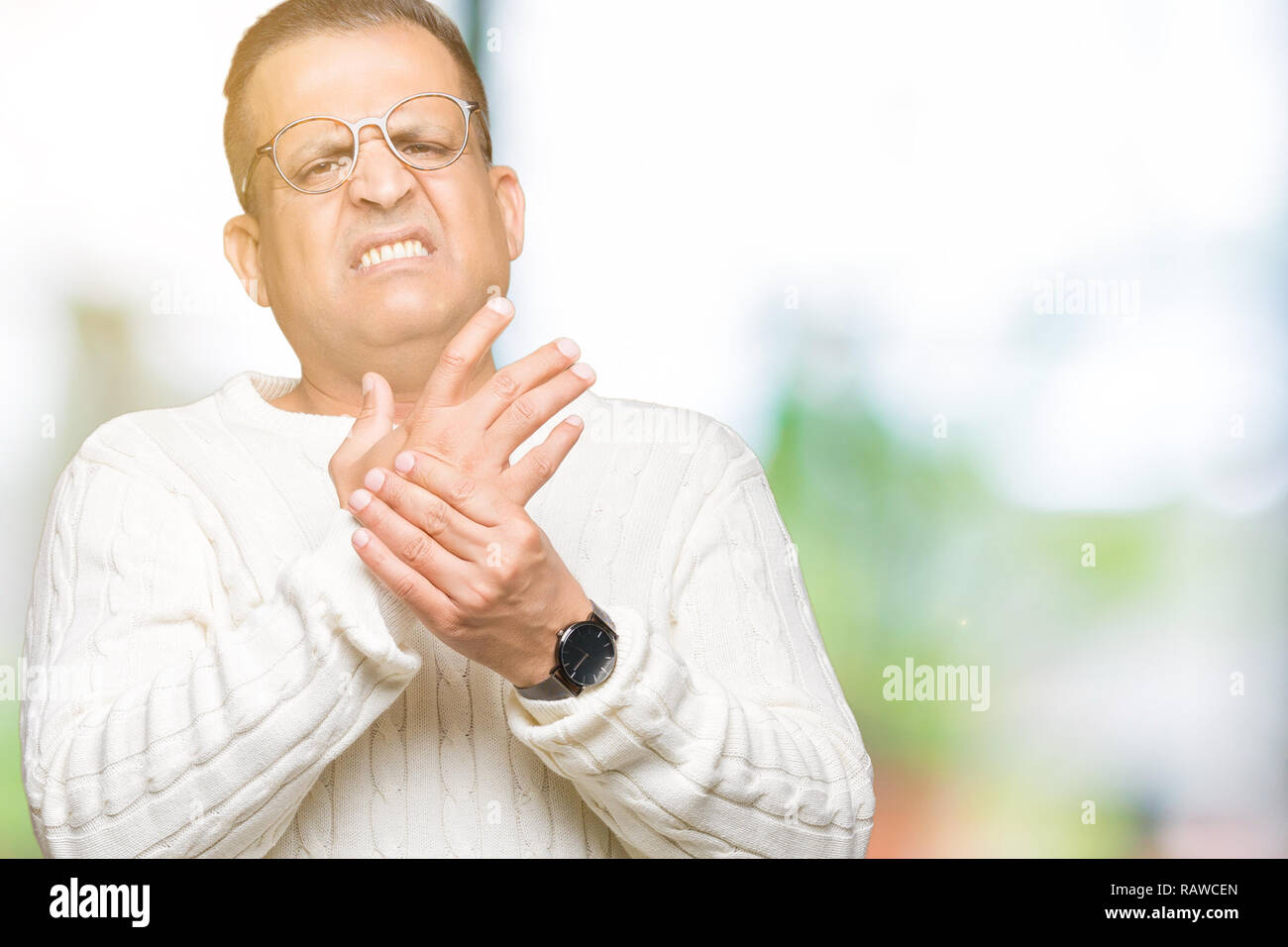 Middle age arab man wearing glasses over isolated background Suffering ...
