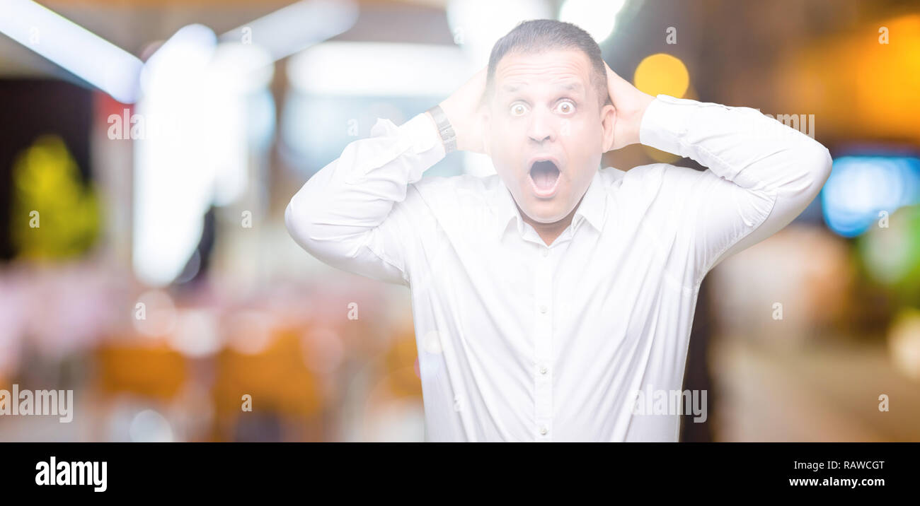 Middle age arab elegant man over isolated background Crazy and scared ...