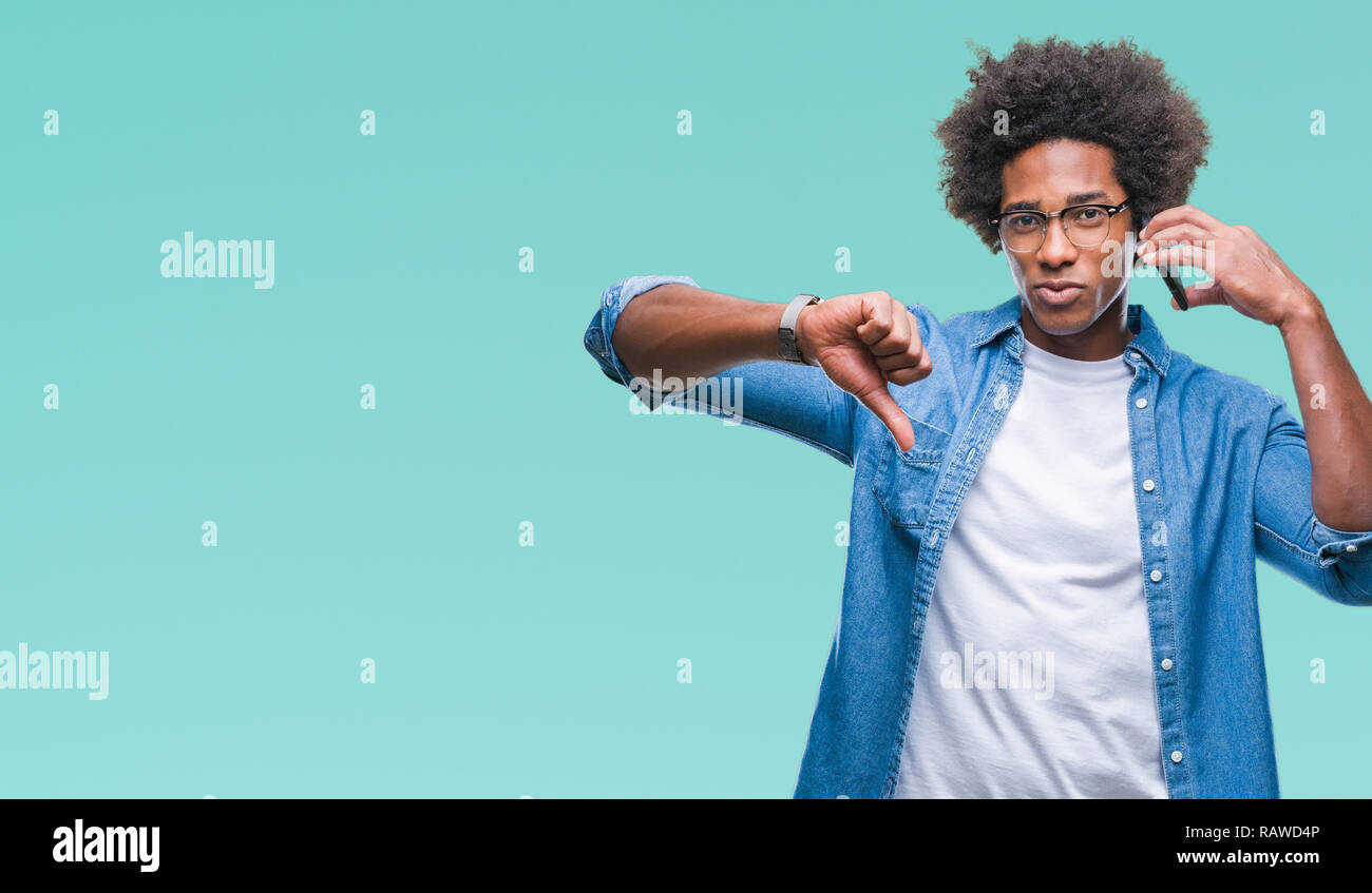 Afro american man talking on the phone over isolated background with ...