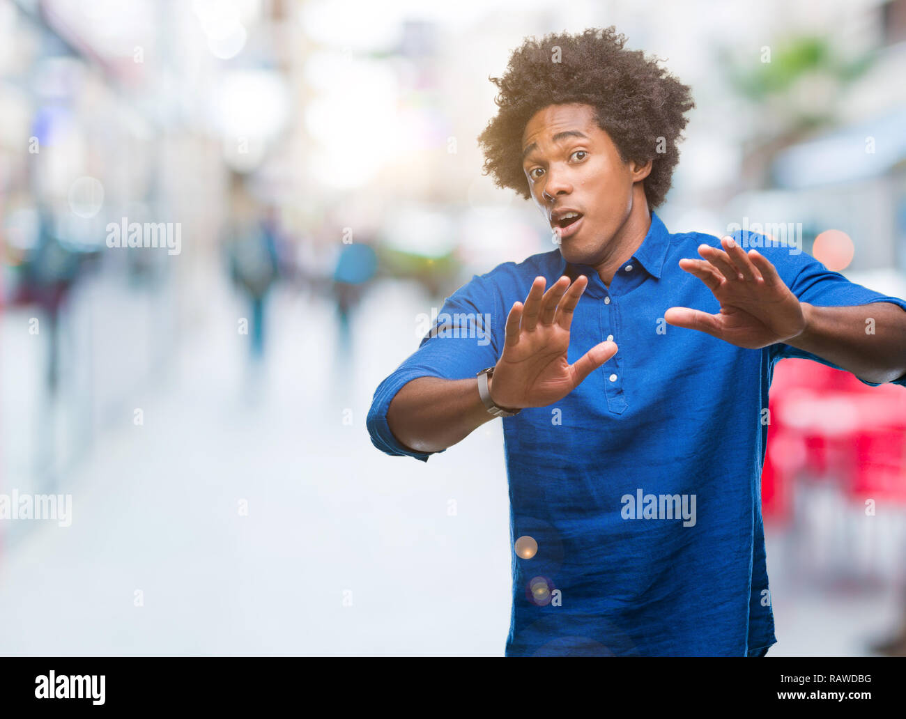 Afro american man over isolated background afraid and terrified with ...