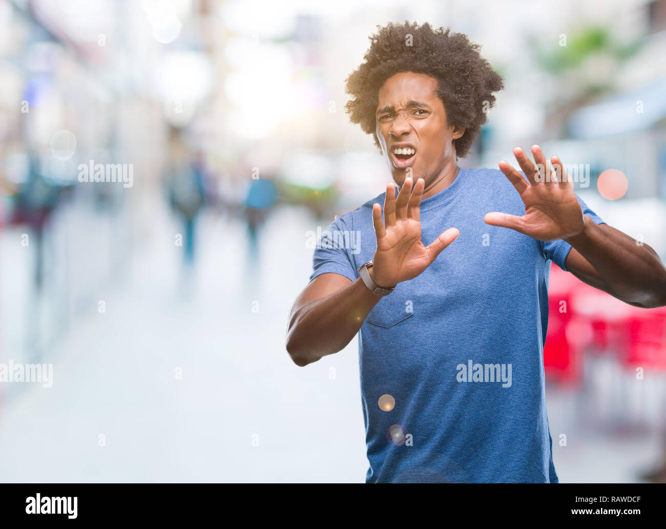 Afro american man over isolated background afraid and terrified with ...