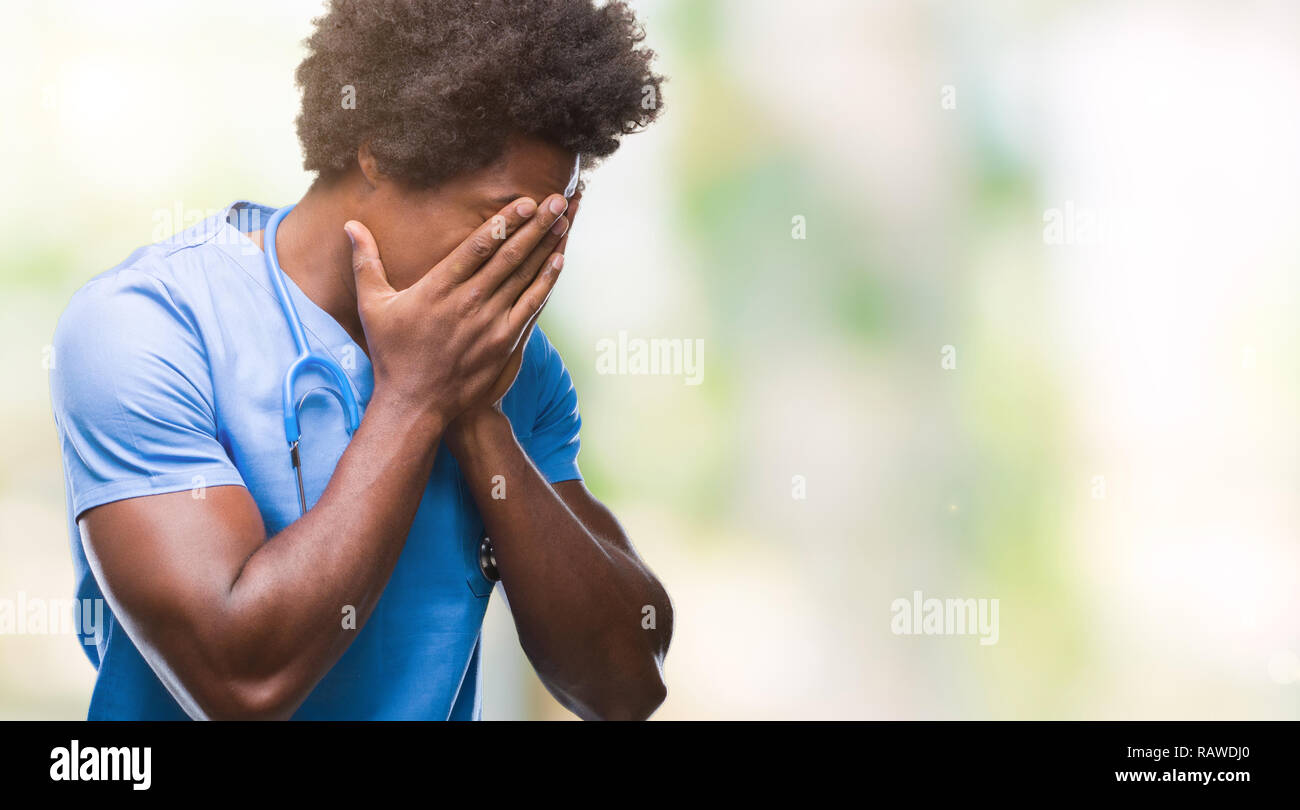 Afro american surgeon doctor man over isolated background with sad ...