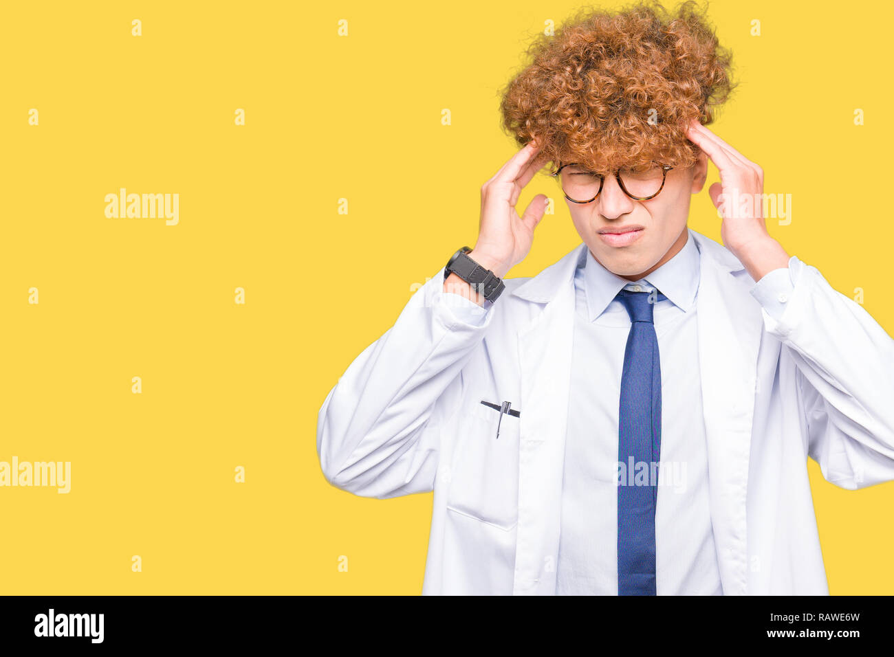 Young handsome scientist man wearing glasses with hand on head for pain ...
