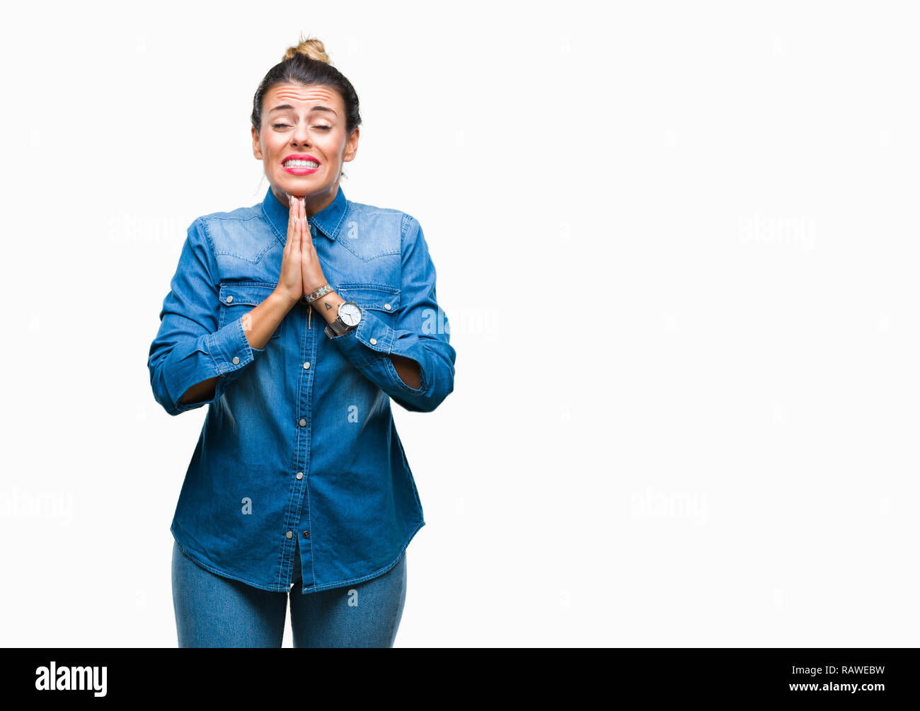 Young beautiful woman over isolated background begging and praying with ...
