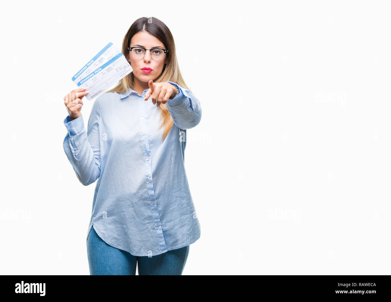 Young beautiful woman holding boarding pass over isolated background ...