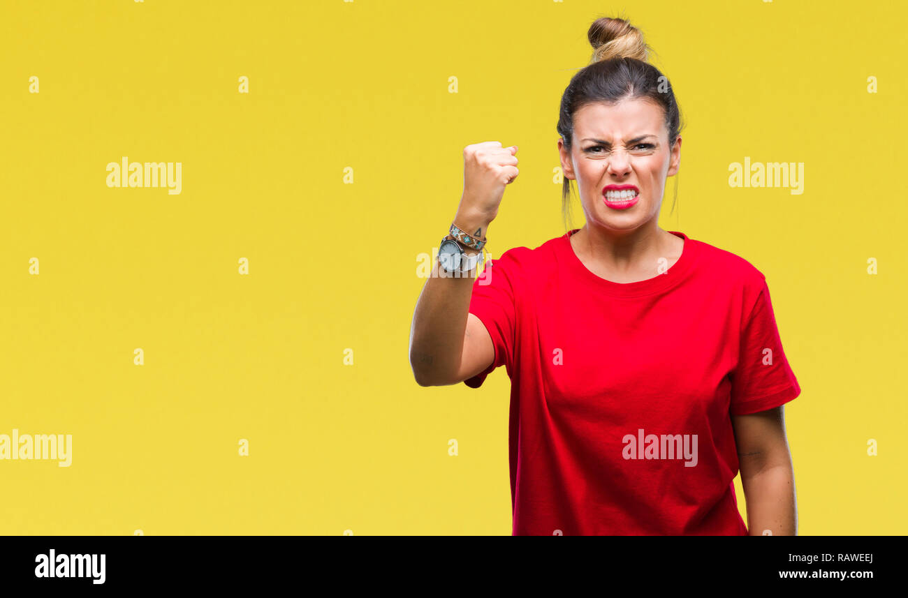 Young beautiful woman over isolated background angry and mad raising ...