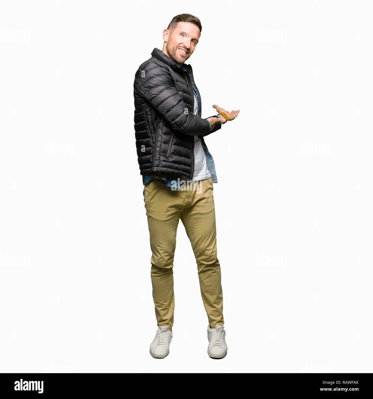 Handsome man wearing winter coat Inviting to enter smiling natural with ...