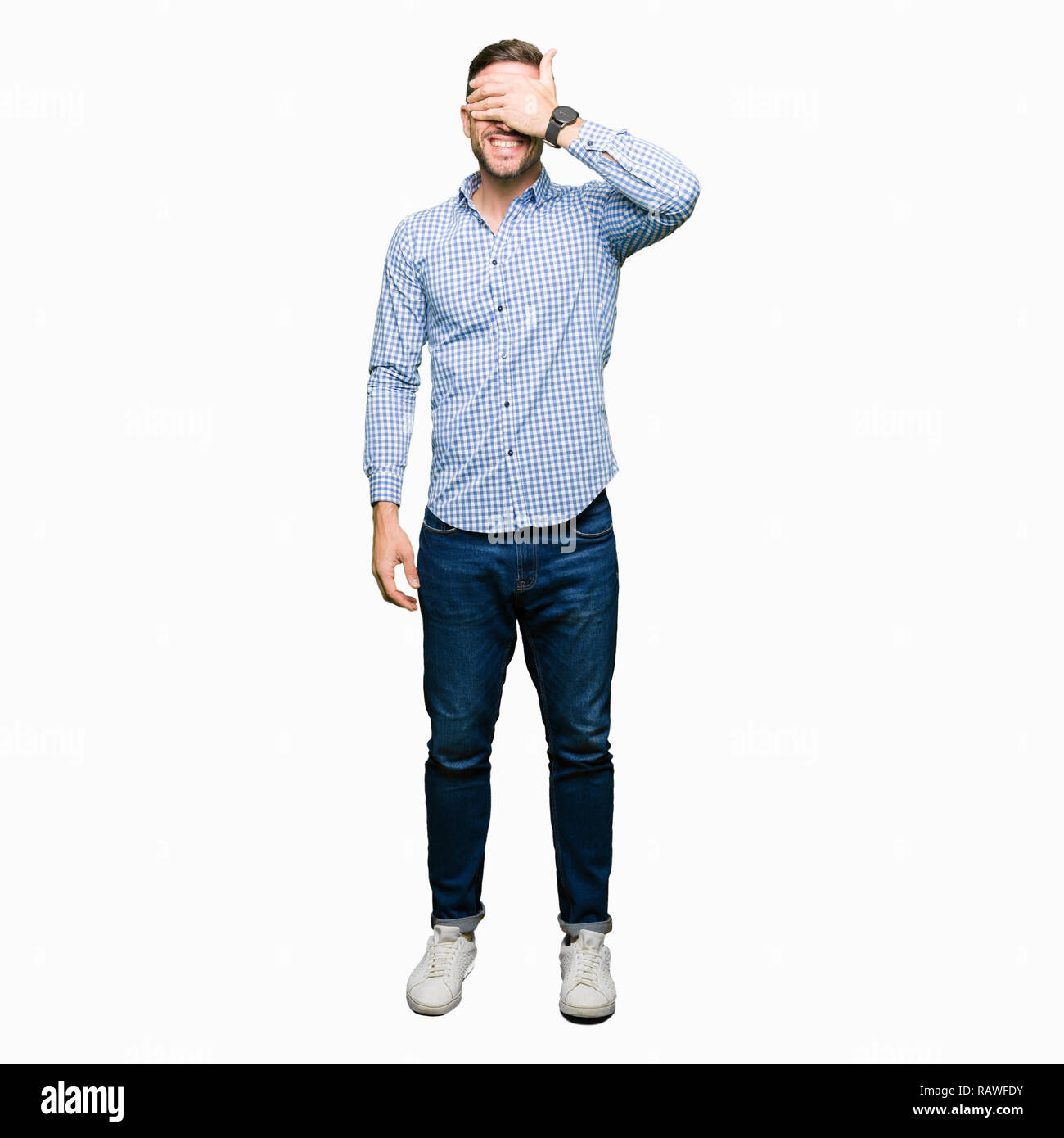 Handsome business man with blue eyes smiling and laughing with hand on ...