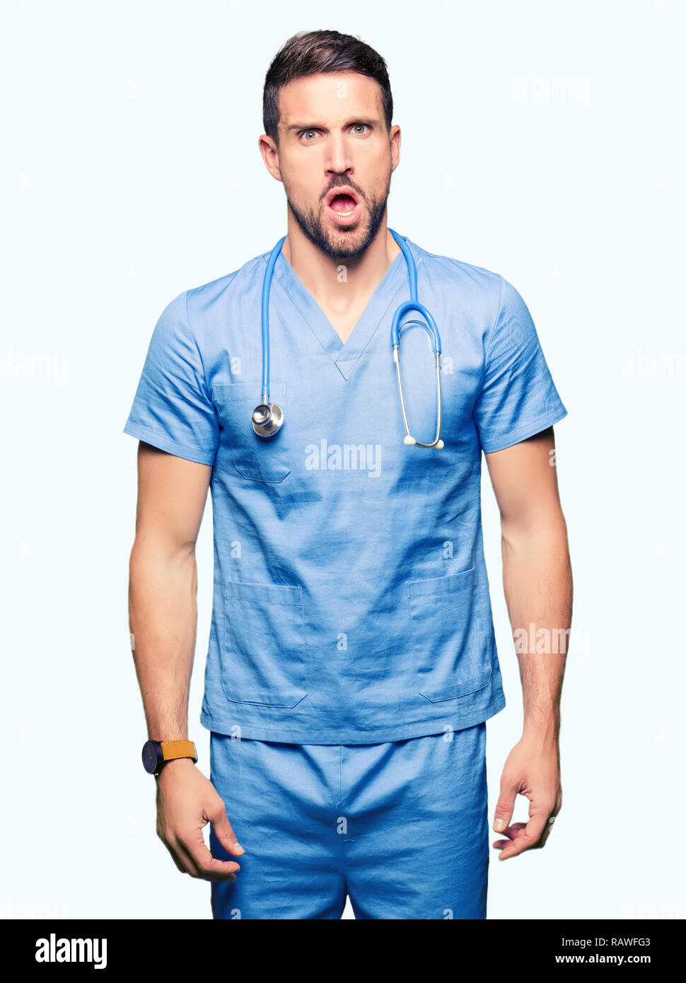 Handsome doctor man wearing medical uniform over isolated background In ...