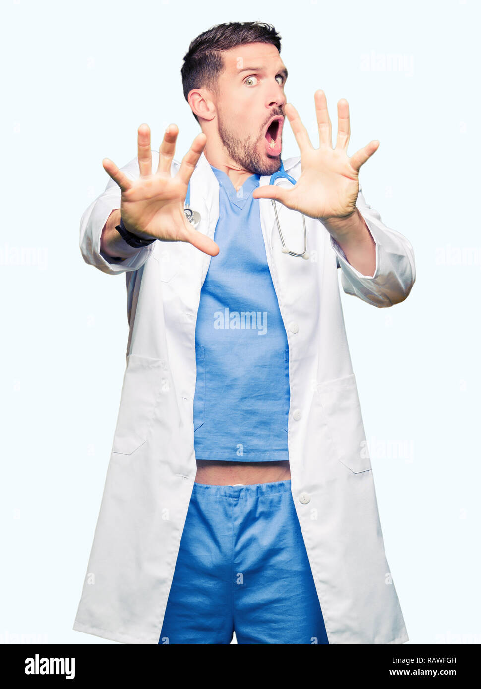 Handsome doctor man wearing medical uniform over isolated background ...