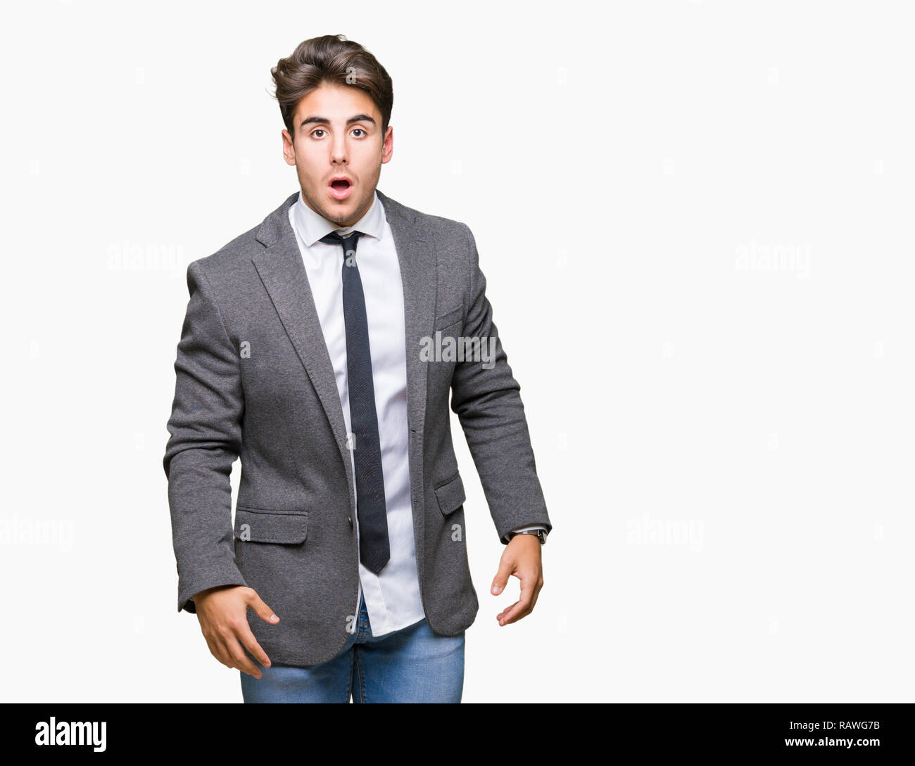 Young business man wearing suit and tie over isolated background afraid ...