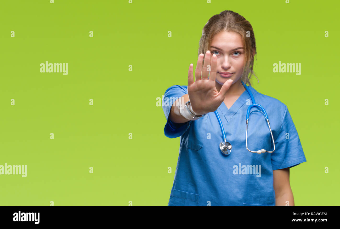 Young caucasian doctor woman wearing surgeon uniform over isolated ...