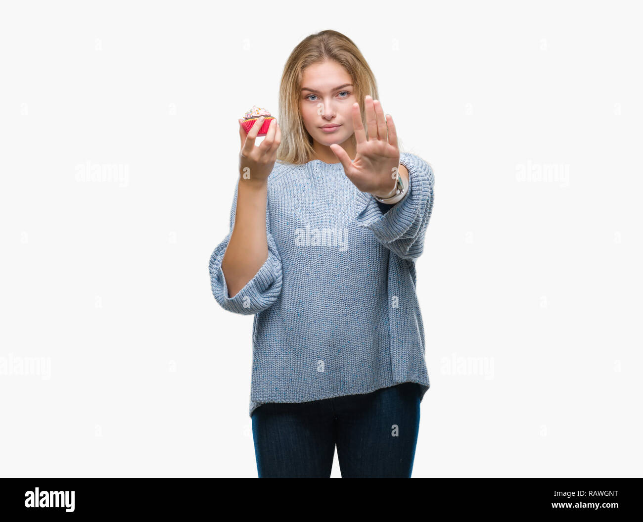 Young caucasian woman eating sweet cupcake over isolated background ...