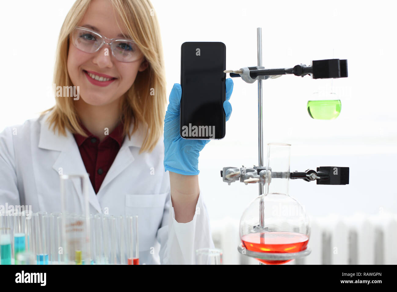 A female doctor in a chemical laboratory holds Stock Photo - Alamy