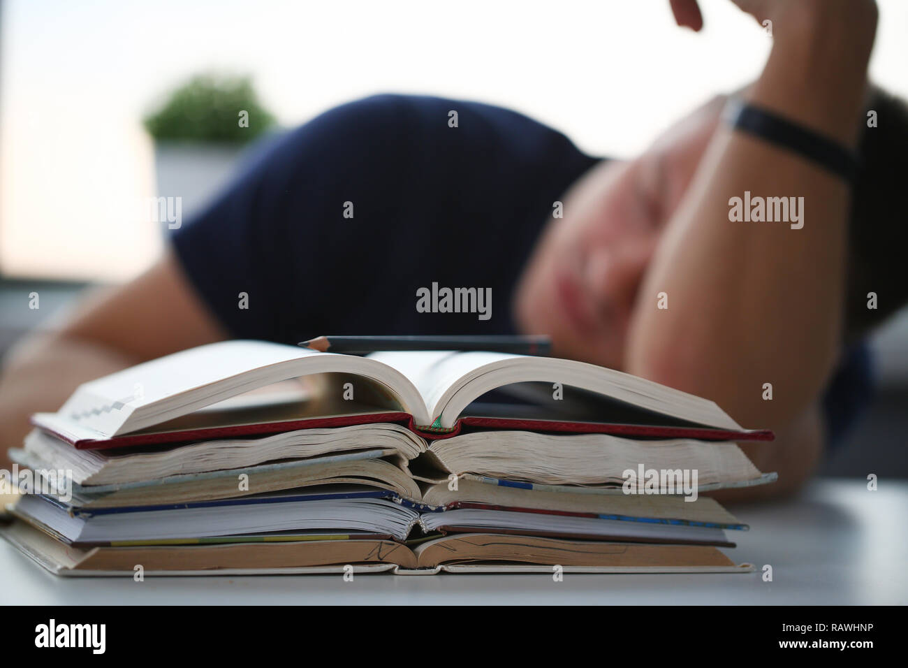 Tired male student at workplace in room Stock Photo - Alamy