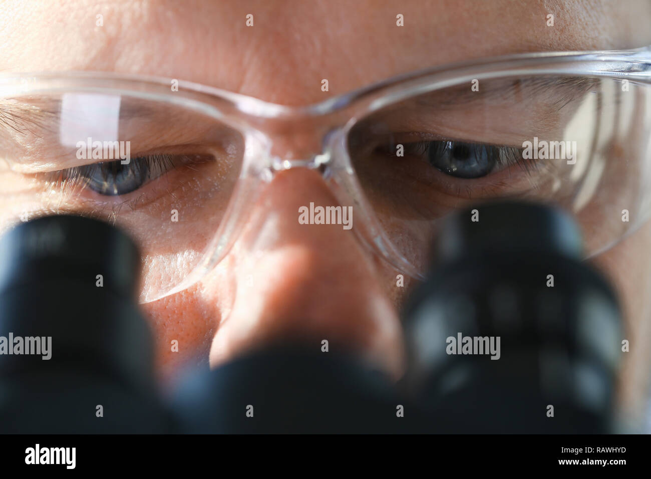 Male scientist looking through binocular Stock Photo - Alamy