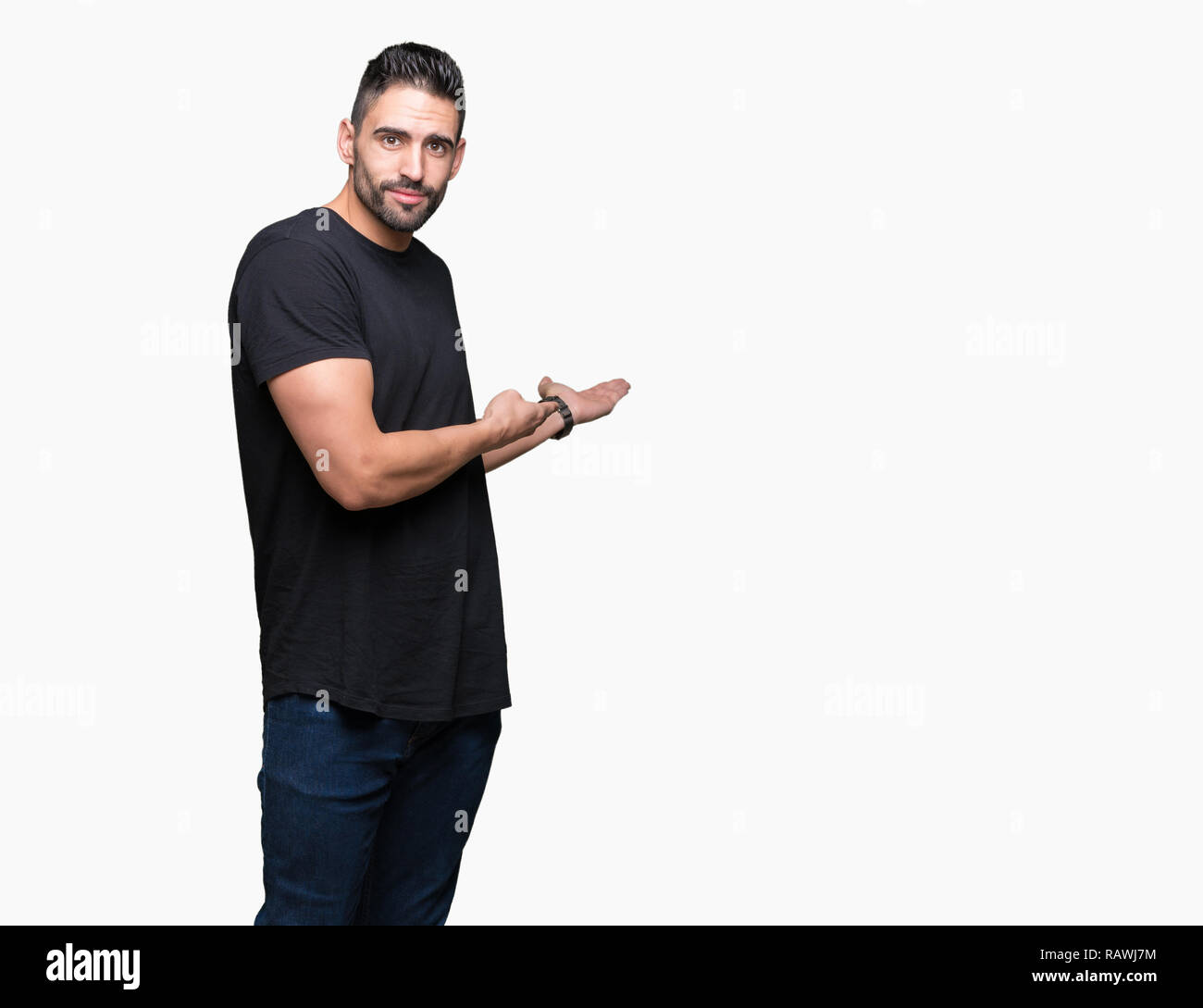 Young handsome man over isolated background Inviting to enter smiling ...