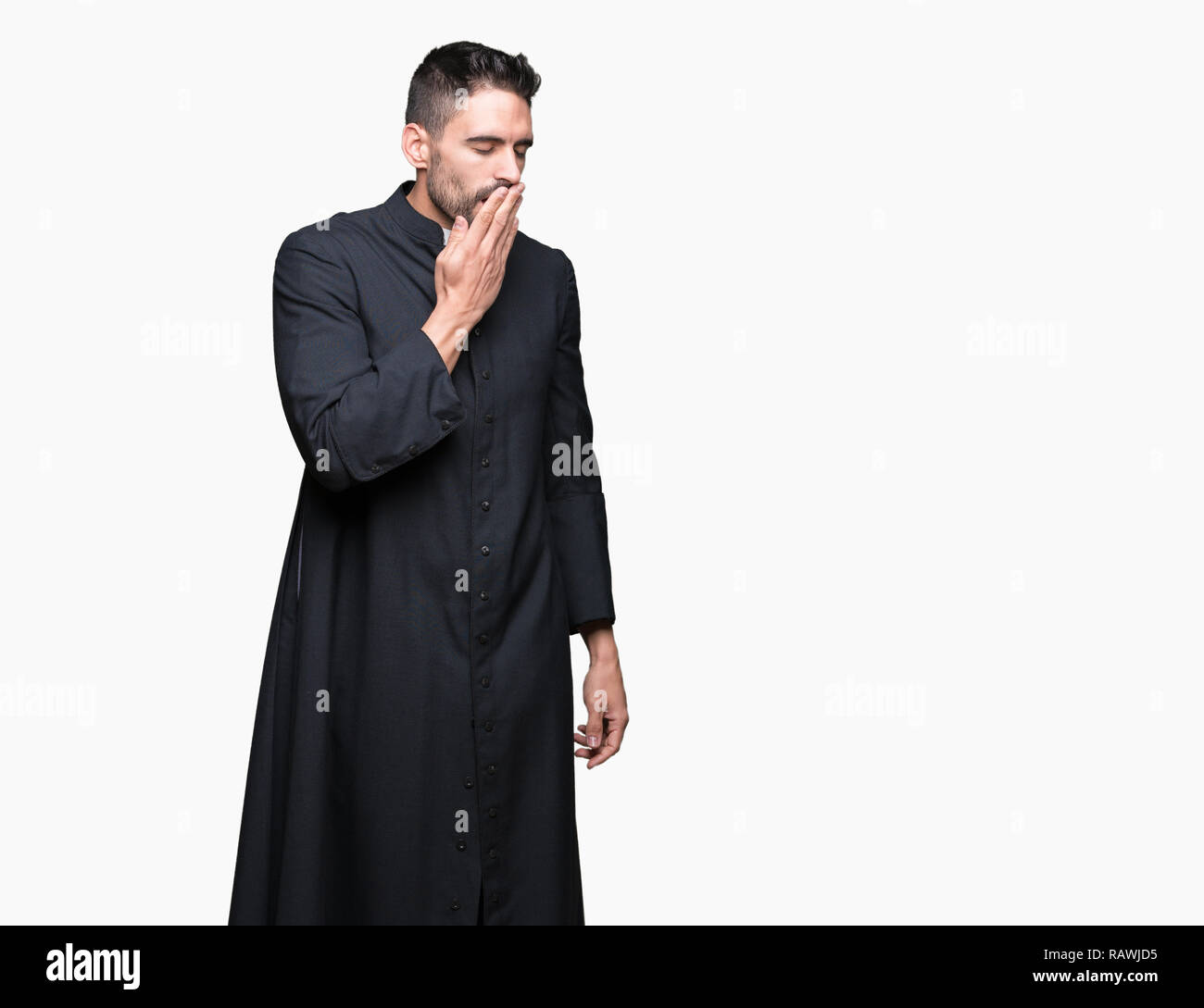 Young Christian priest over isolated background bored yawning tired ...