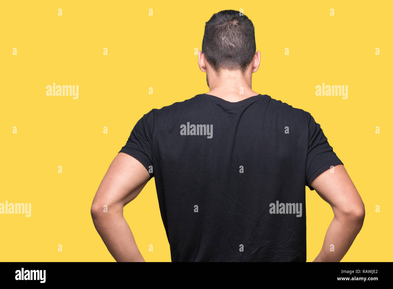 Young handsome man over isolated background standing backwards looking ...