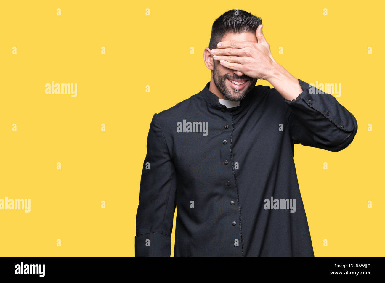 Young Christian priest over isolated background smiling and laughing ...