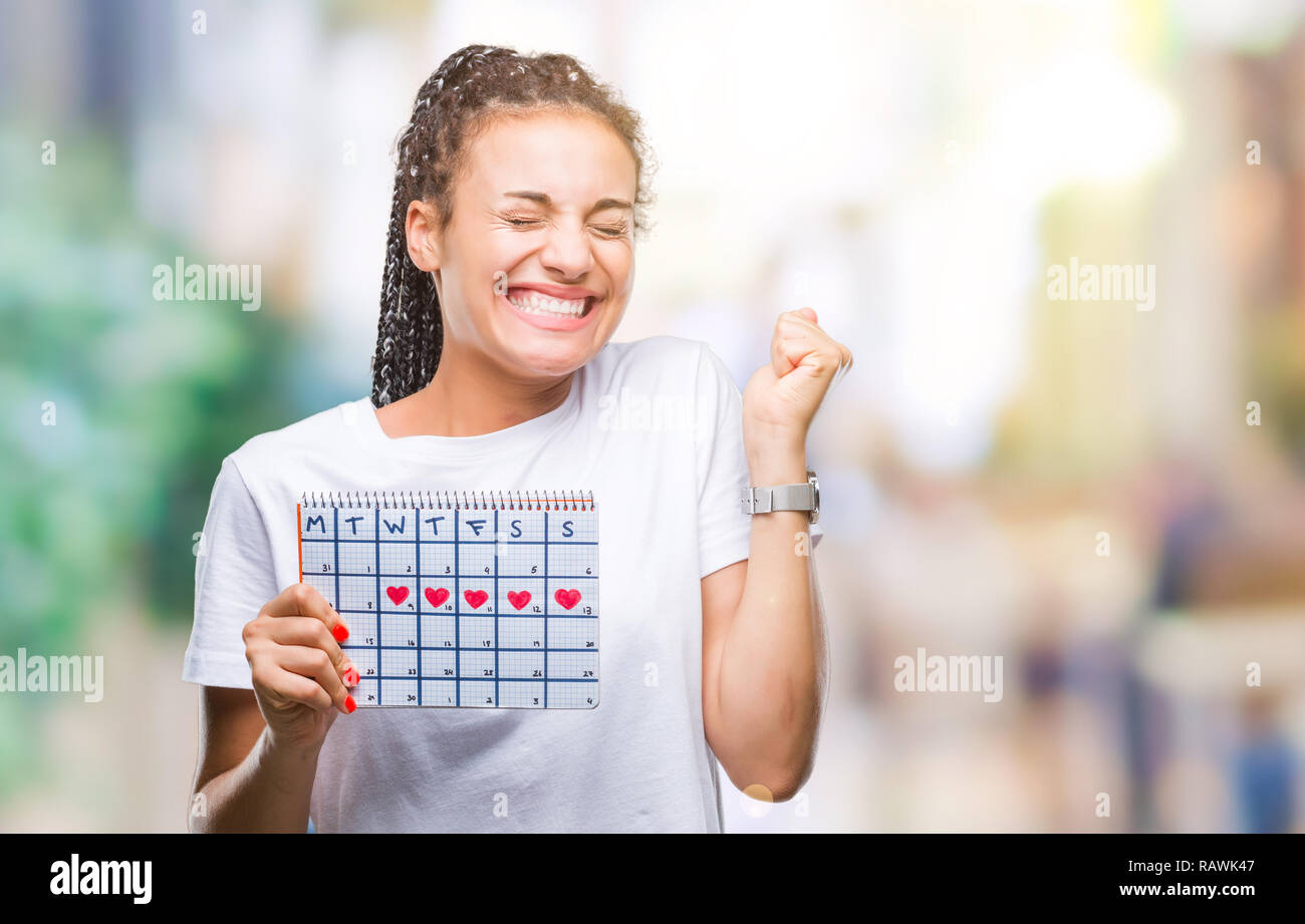 Young braided hair african american girl holding menstruation calendar ...