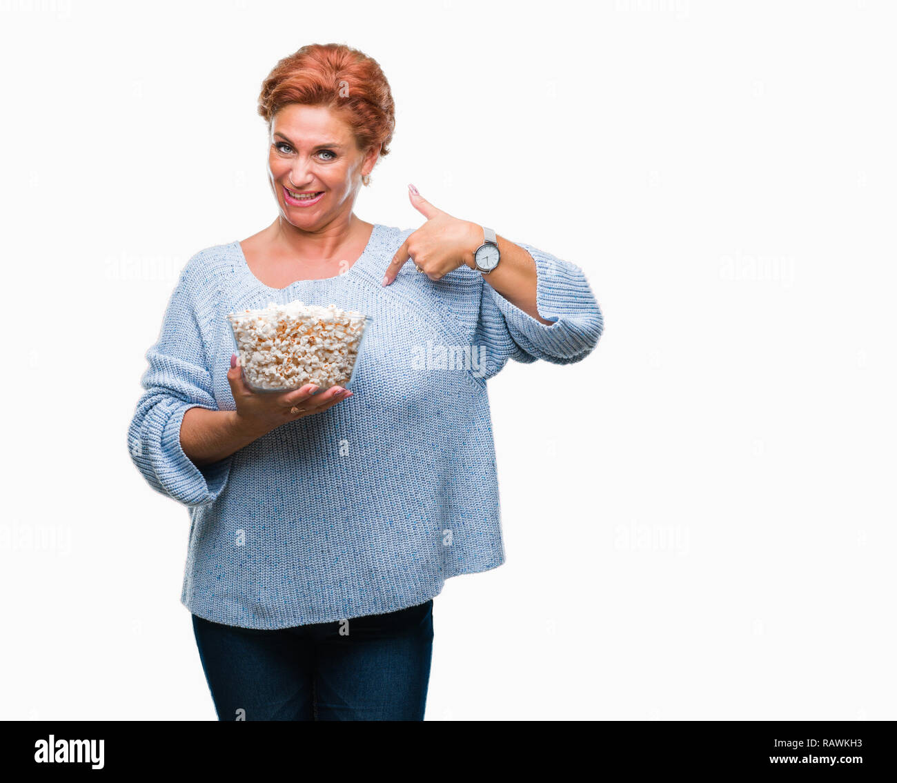 Atrractive Senior Caucasian Redhead Woman Eating Popcorn Over Isolated