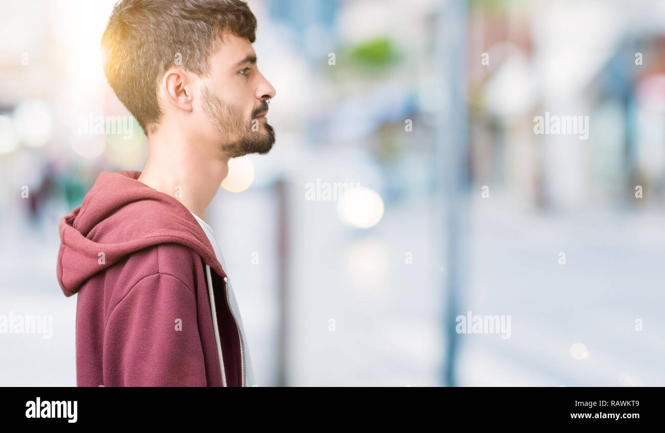Young handsome man over isolated background looking to side, relax ...