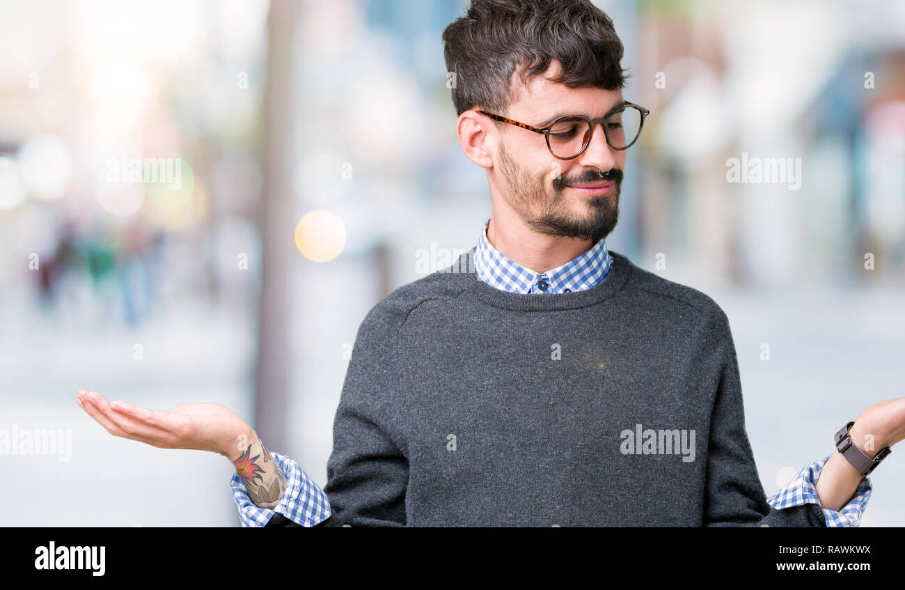 Young handsome smart man wearing glasses over isolated background ...