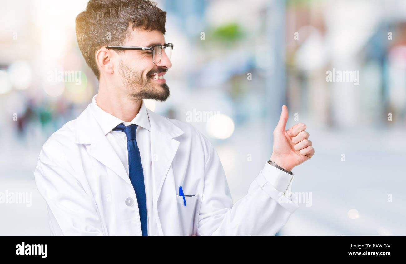 Young professional scientist man wearing white coat over isolated ...