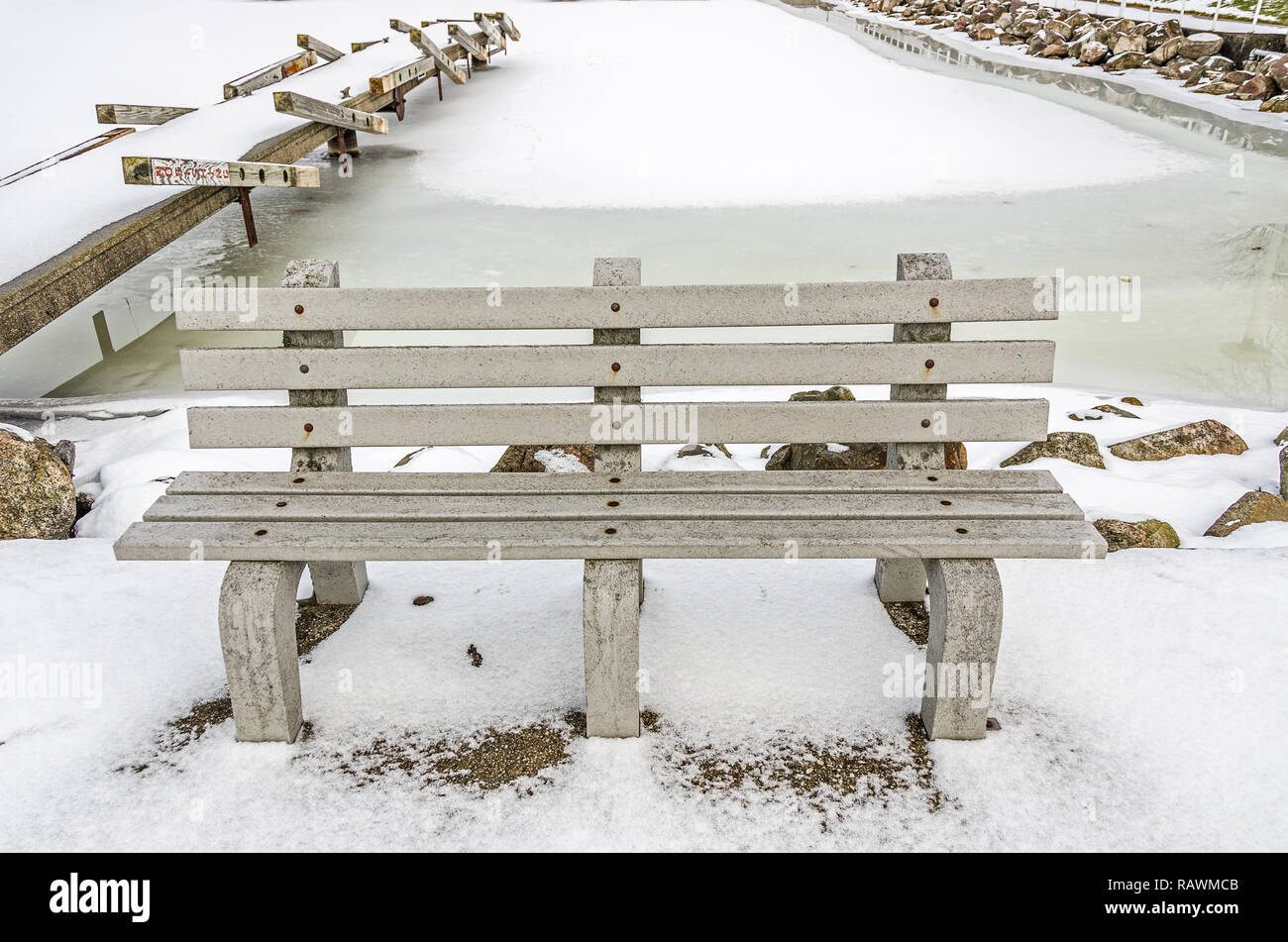 Cold bench offering quiet and solitude with a fresh coat of snow around ...