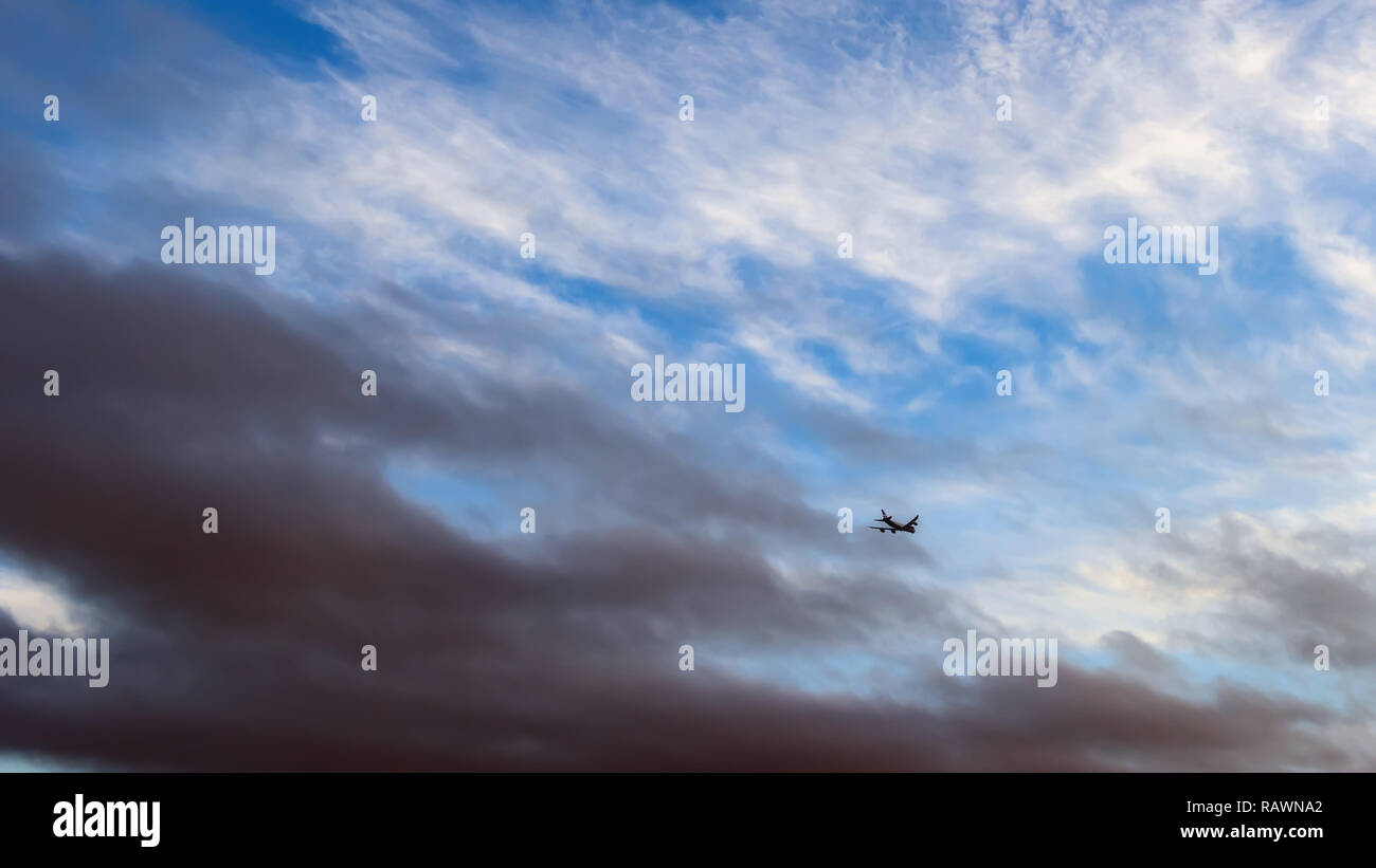 Passenger airliner in the colorful sky Stock Photo - Alamy