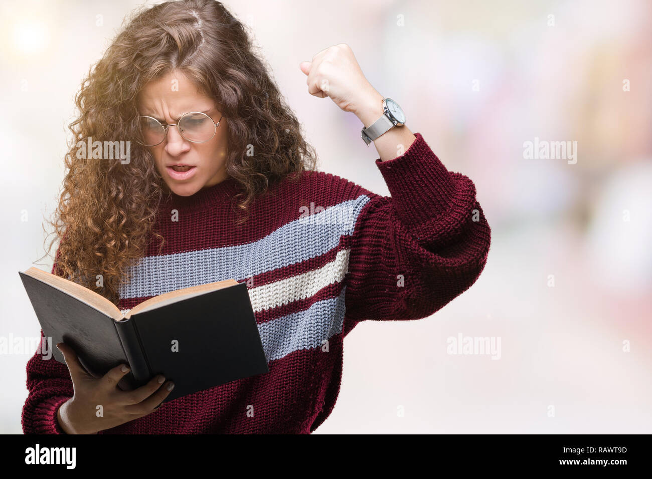 Young brunette girl reading a book wearing glasses over isolated ...