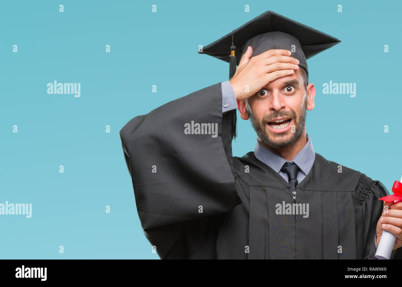 Young handsome graduated man holding degree over isolated background ...