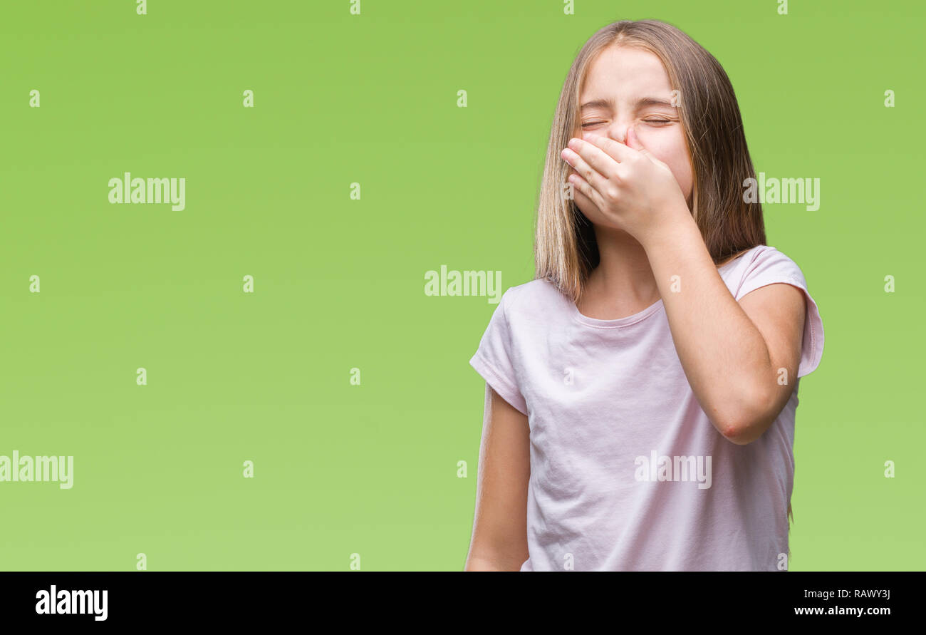 Young beautiful girl over isolated background smelling something stinky ...