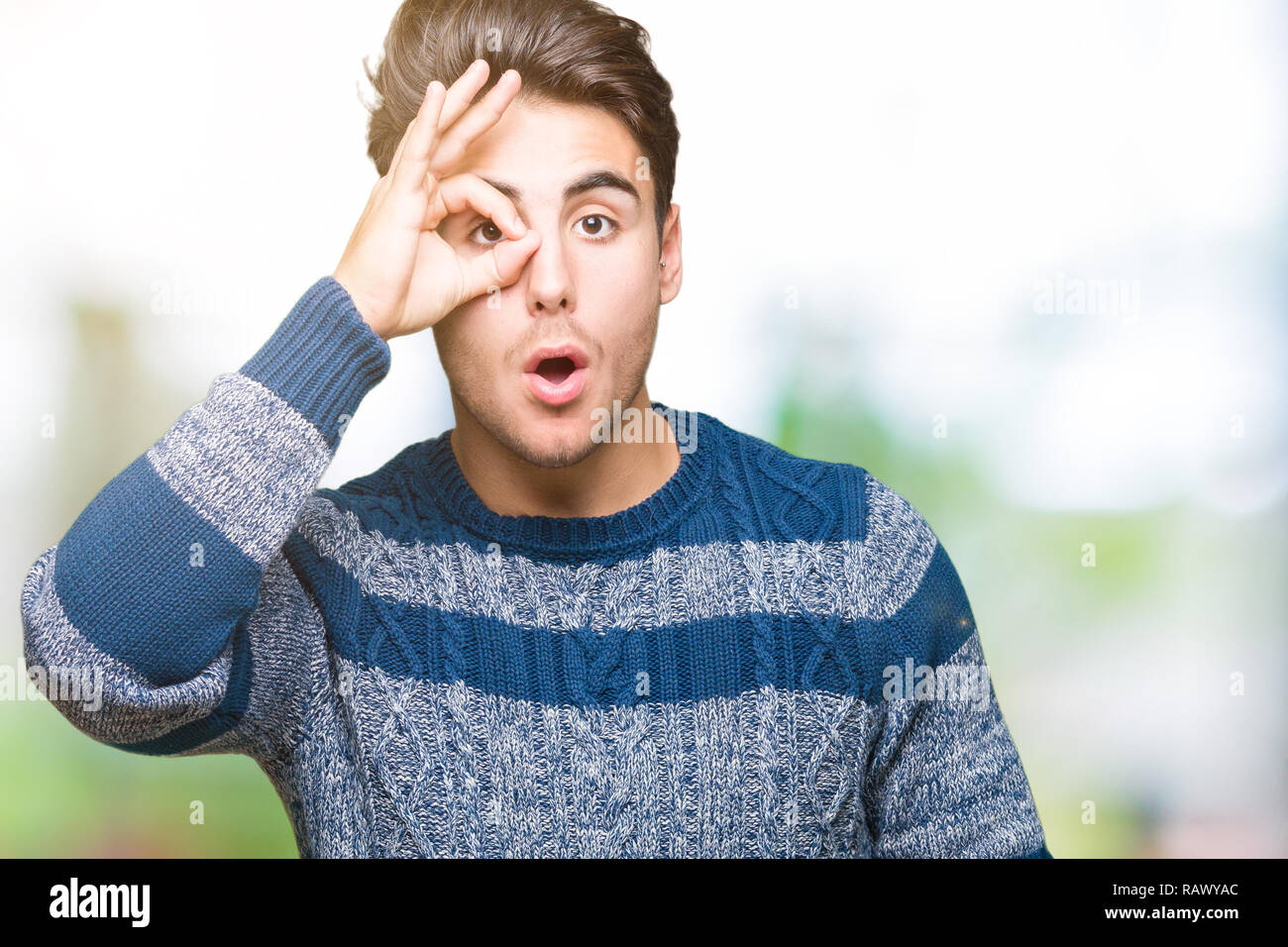 Young handsome man over isolated background doing ok gesture shocked ...