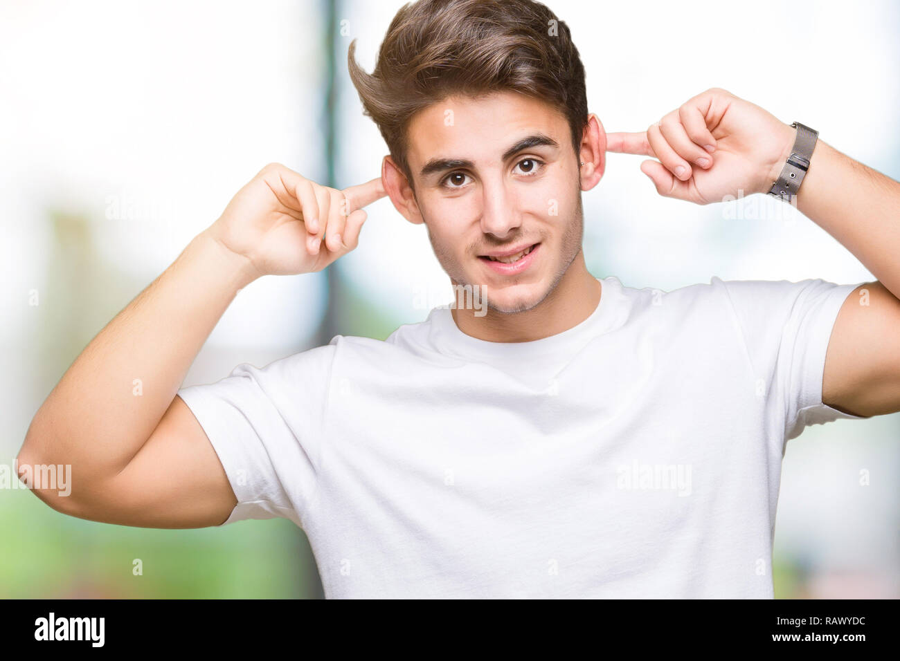 Young handsome man wearing white t-shirt over isolated background ...