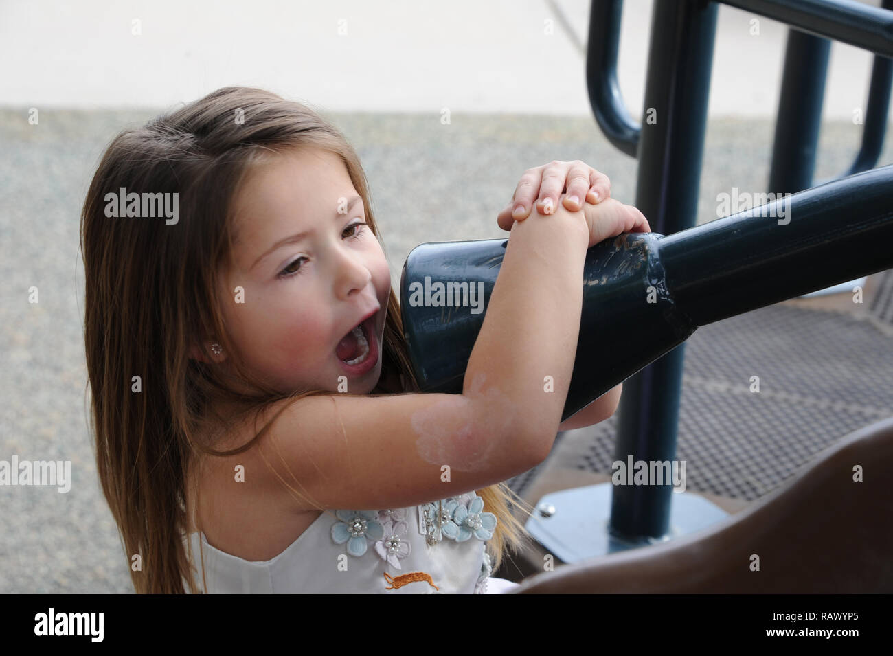 Young Girl Singing Into a Playground Funnel Wearing a Princess Dress ...
