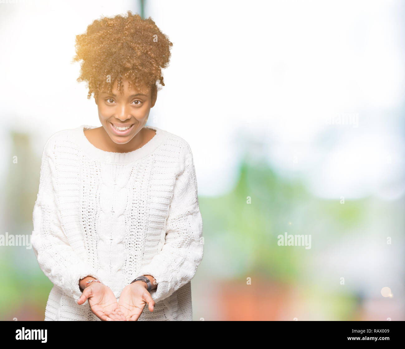 Beautiful young african american woman wearing winter sweater over ...