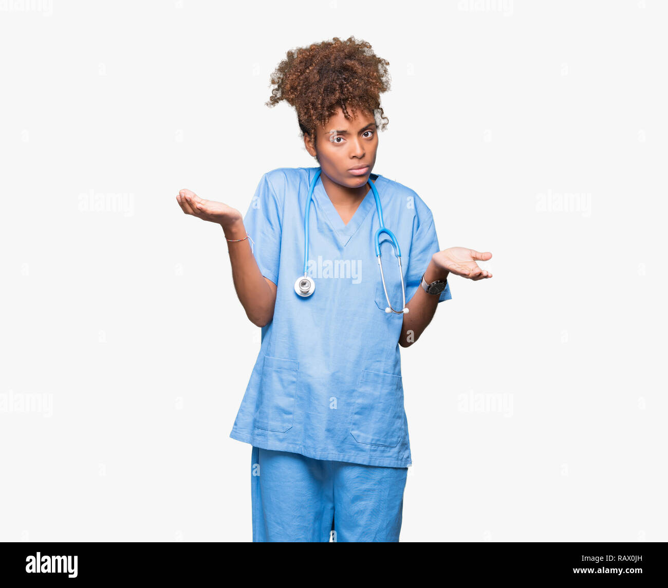 Young african american doctor woman over isolated background clueless ...