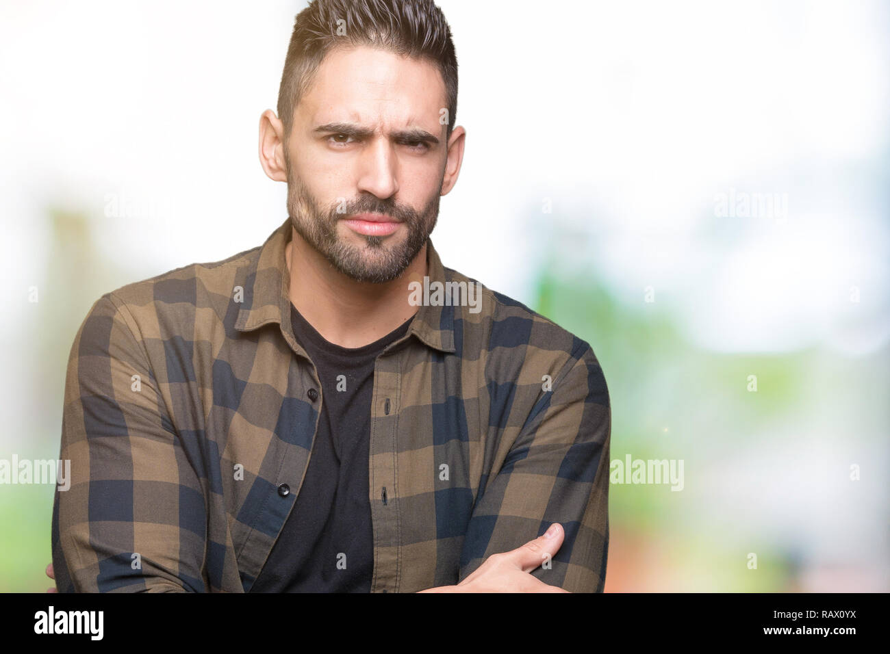 Young handsome man over isolated background skeptic and nervous ...
