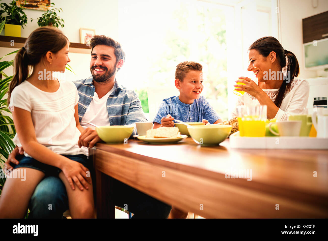 Happy family having breakfast Stock Photo - Alamy