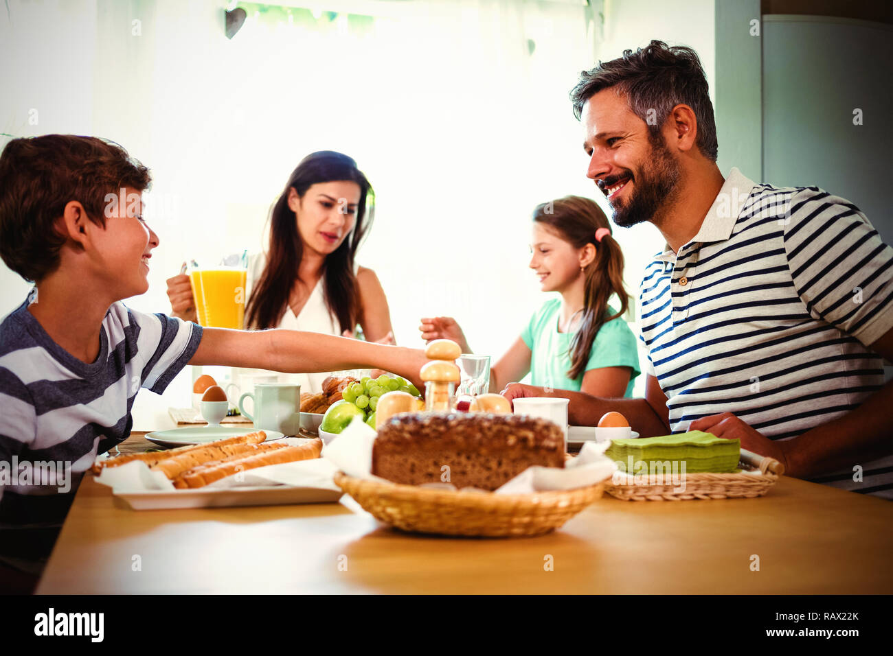 Happy family having breakfast Stock Photo - Alamy