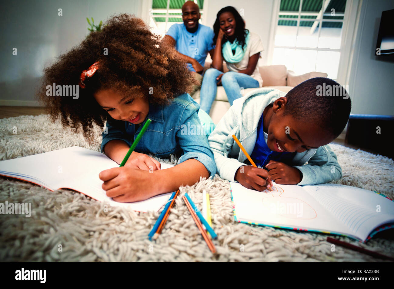 Children doing their homework with parents in background Stock Photo ...
