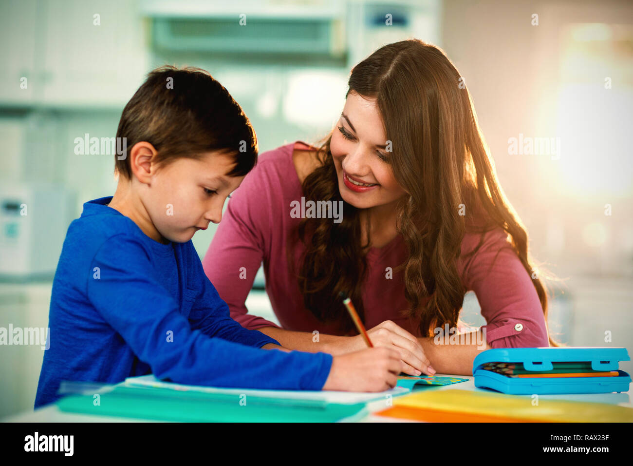 Mother helping son with homework hi-res stock photography and images - Alamy