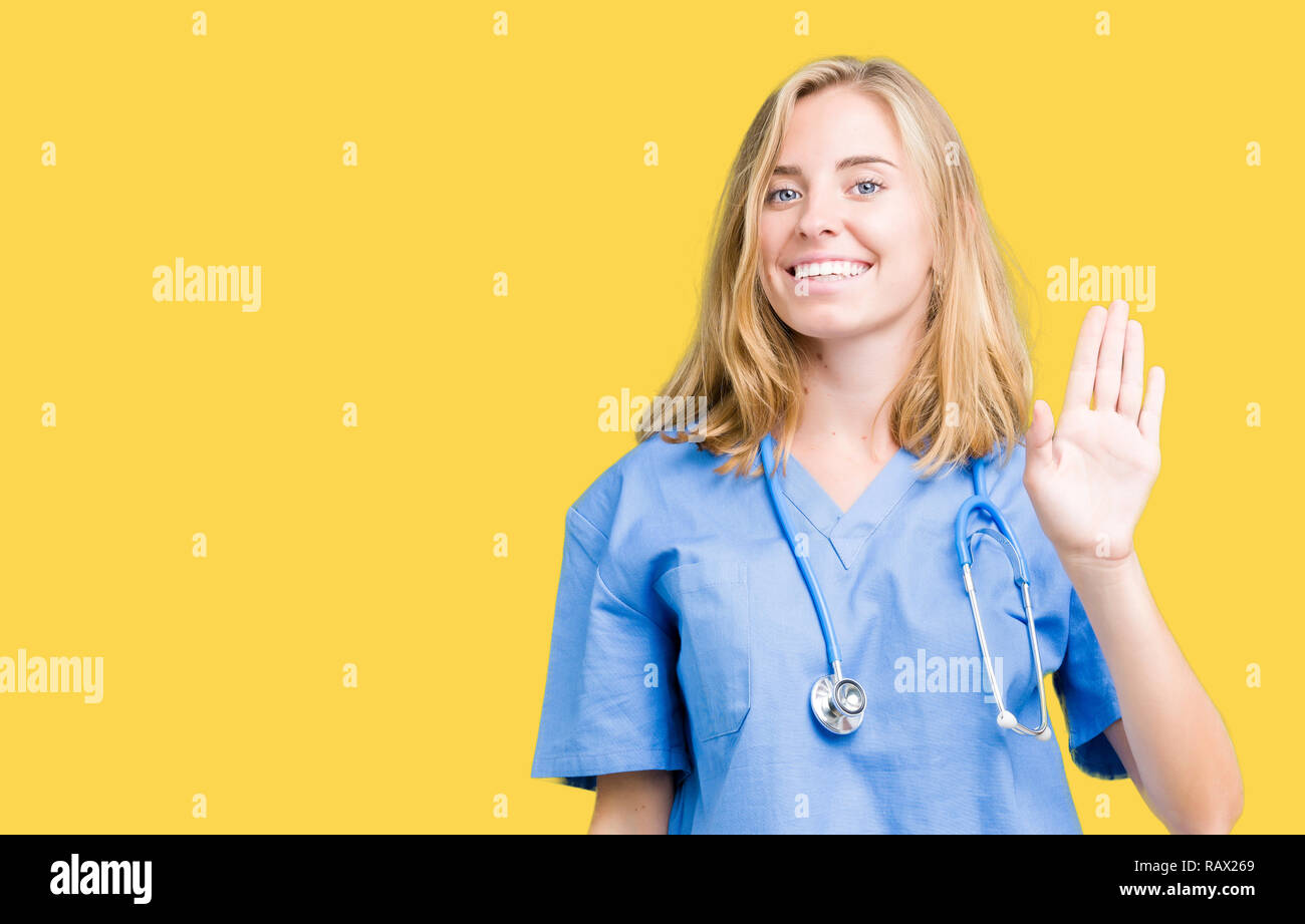 Beautiful young doctor woman wearing medical uniform over isolated ...