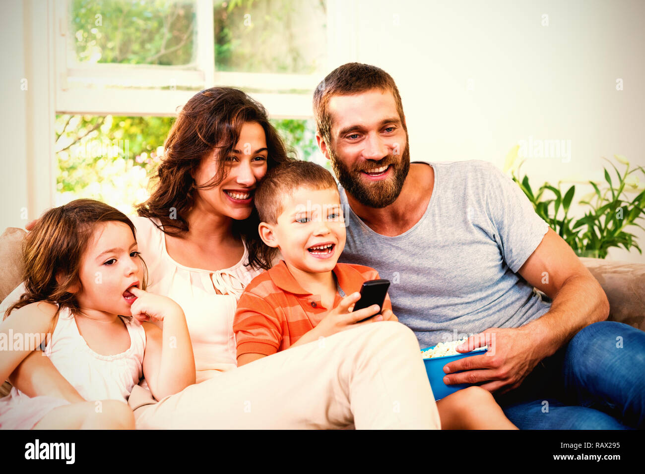 Family having fun while watching television Stock Photo - Alamy