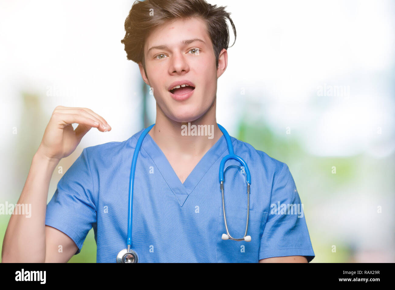 Young doctor wearing medical uniform over isolated background gesturing ...