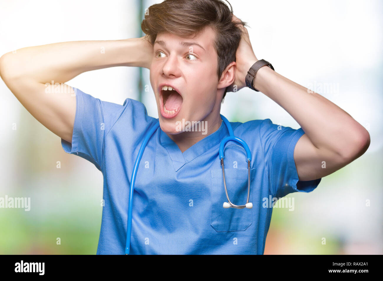 Young doctor wearing medical uniform over isolated background Crazy and ...