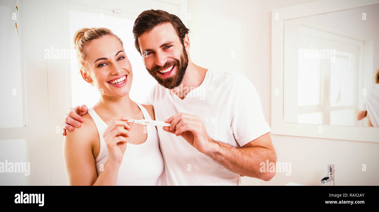 Portrait of happy couple checking pregnancy test Stock Photo - Alamy