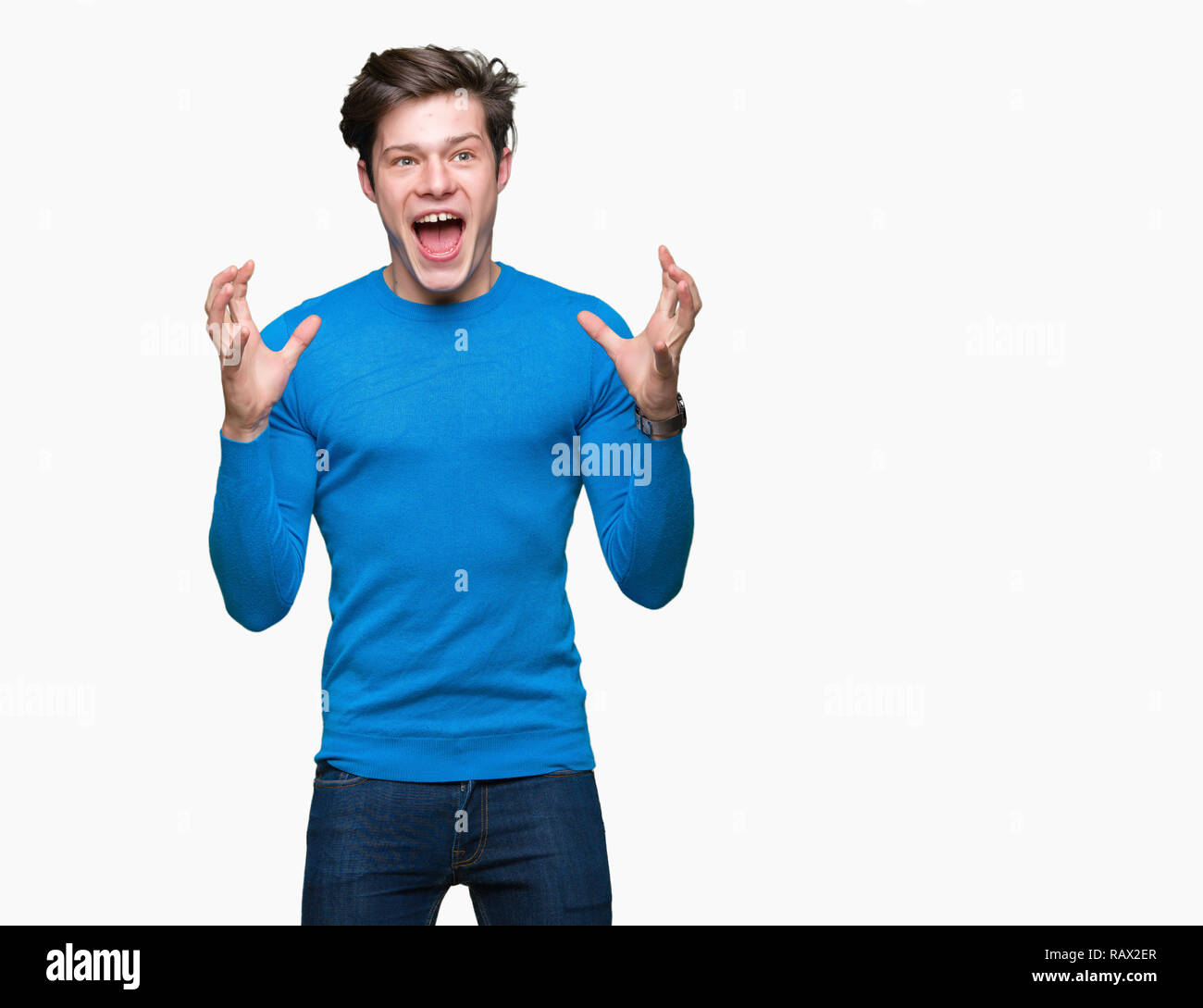 Young handsome man wearing blue sweater over isolated background crazy ...